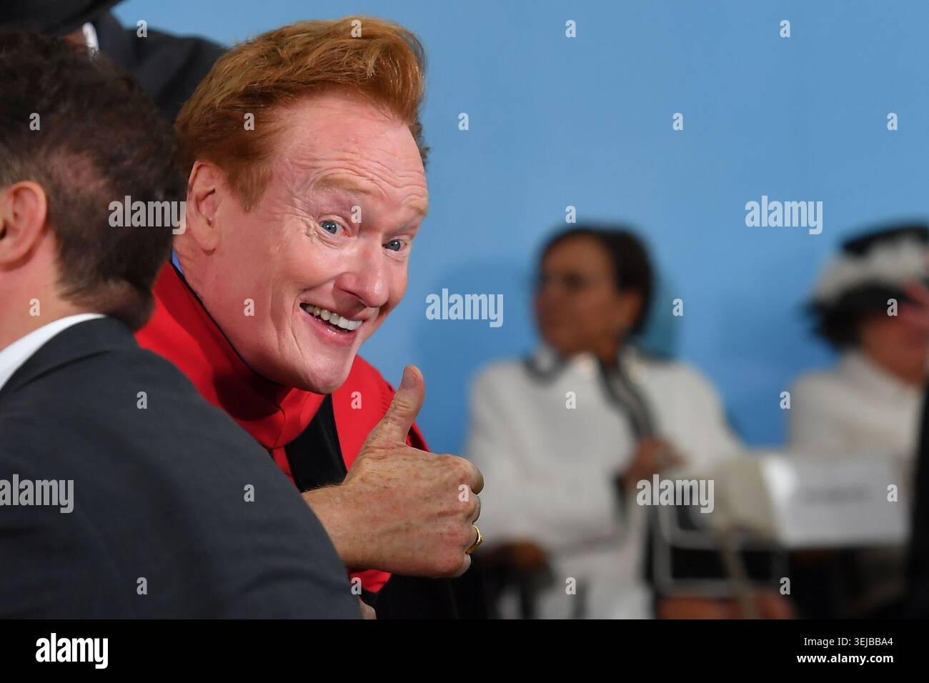 Comedian Conan O'Brien gestures from the stage during Harvard ...