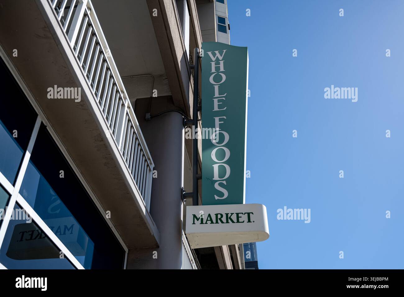 Whole Foods Market sign on side of mixed-use building against clear ...