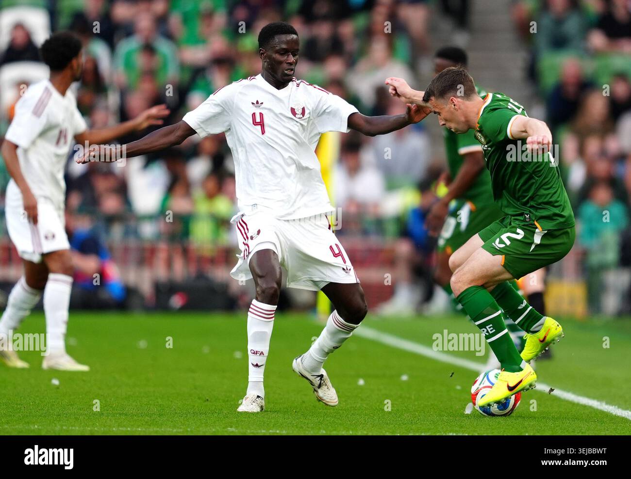 Qatar's Gueye Laye (left) and Republic of Ireland's Seamus Coleman ...