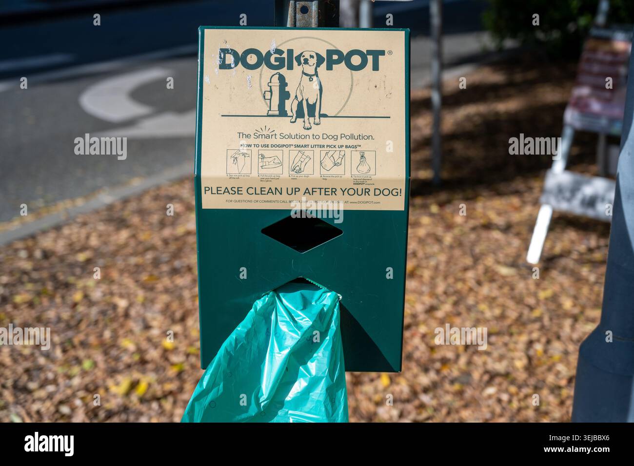 Dog waste bag dispenser with Dogipot signage in a leafy neighborhood ...