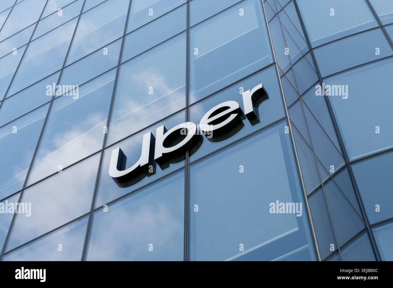 Uber logo on glass facade of modern office building, San Francisco ...