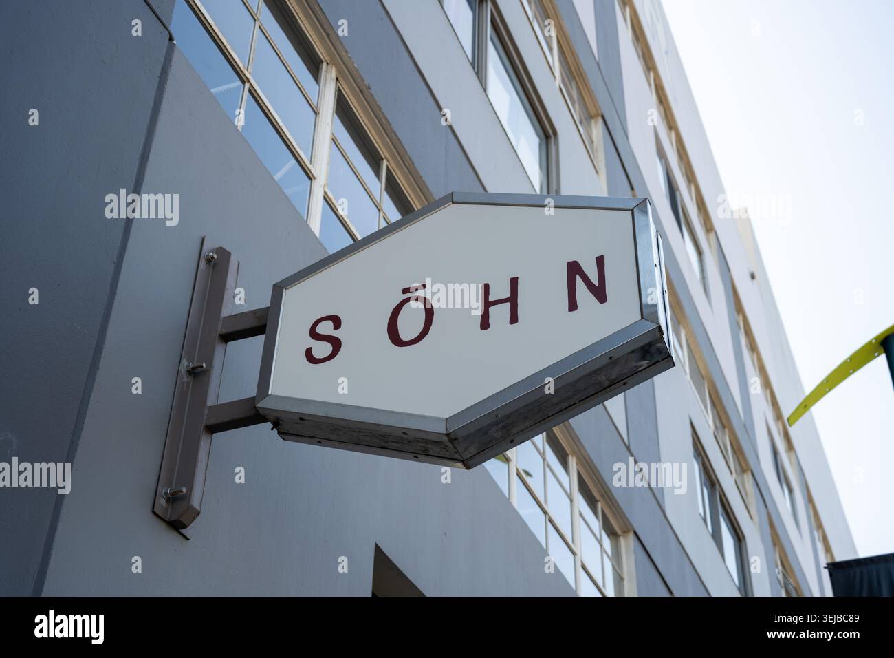 Hanging sign with Sohn logo on exterior of gray building, San Francisco ...