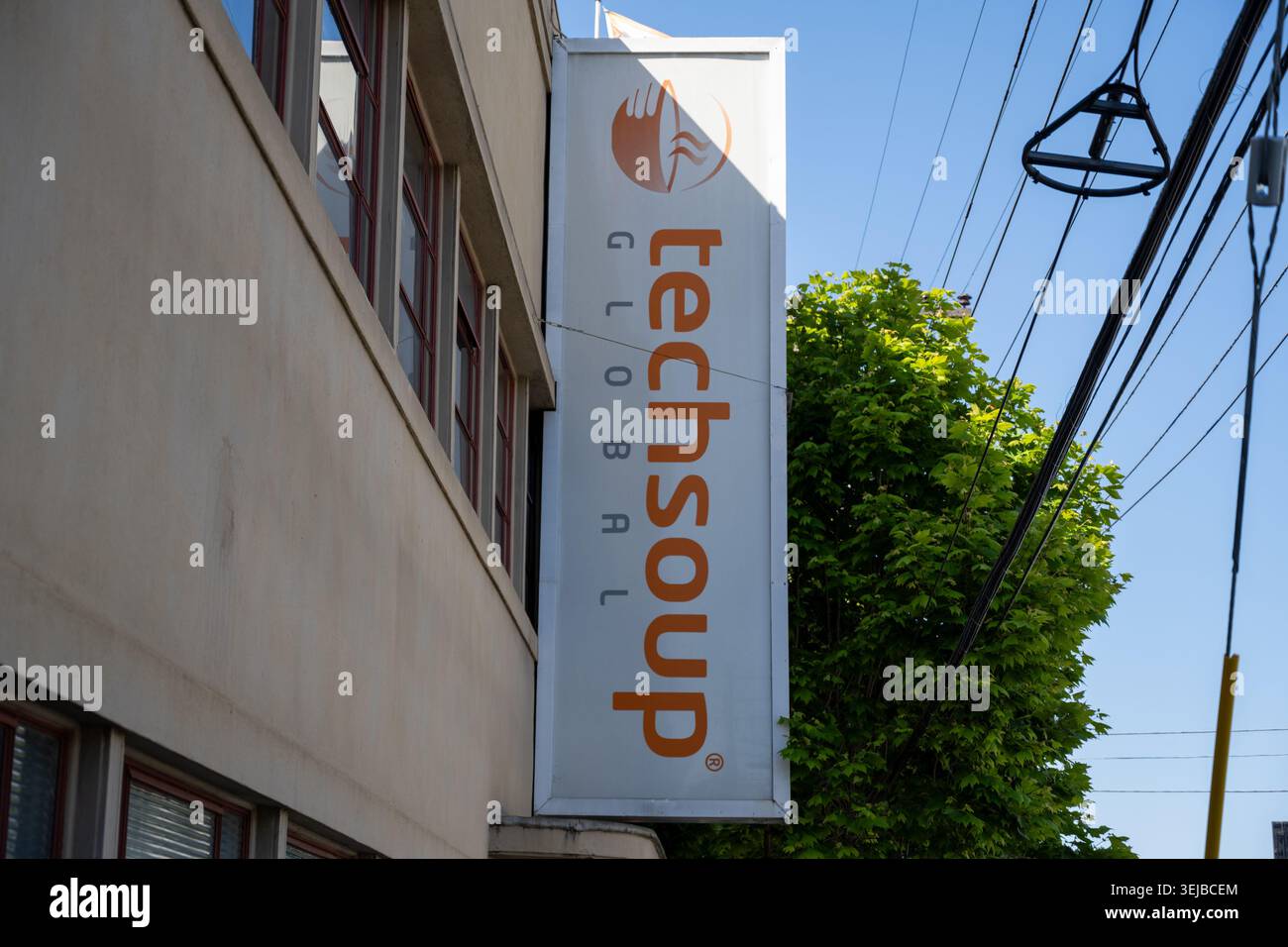 Vertical TechSoup Global sign on exterior of a building with tree and ...