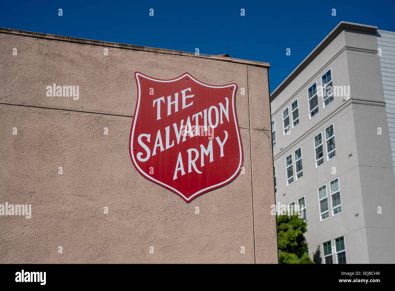 Salvation Army shield logo mounted on exterior wall of a building on a ...