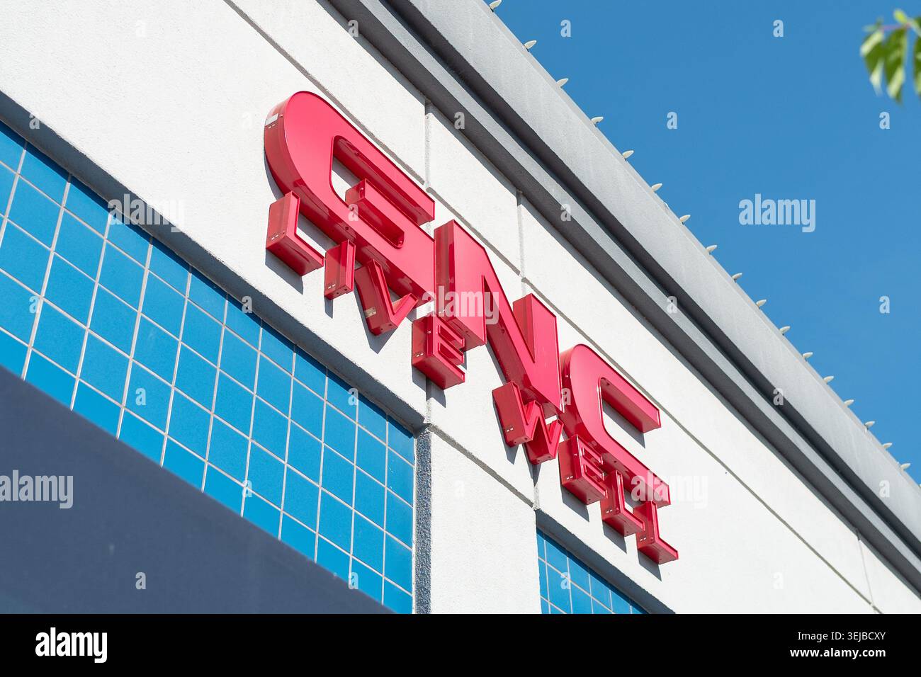 GNC Live Well sign on exterior of commercial building with blue tile ...
