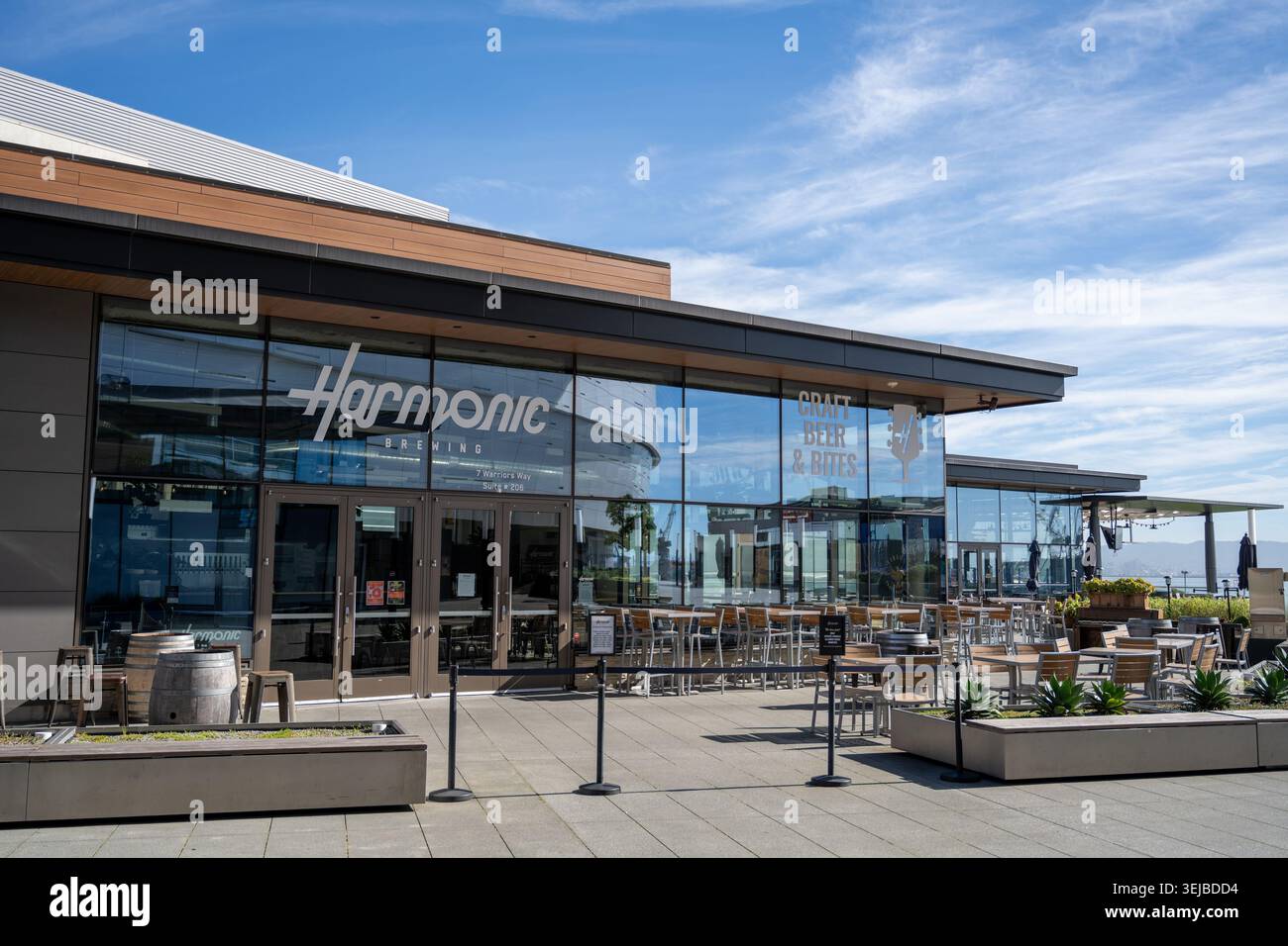 Exterior of Harmonic Brewing building with outdoor seating area on a ...