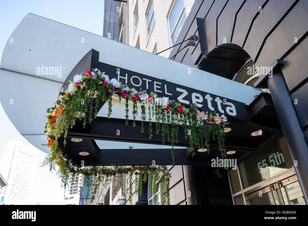 Entrance canopy of Hotel Zetta with floral decorations and building ...