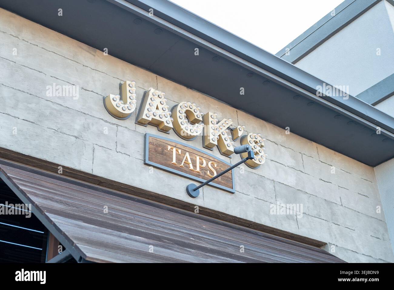 Exterior sign for Jacks Taps on a concrete building on a clear day ...