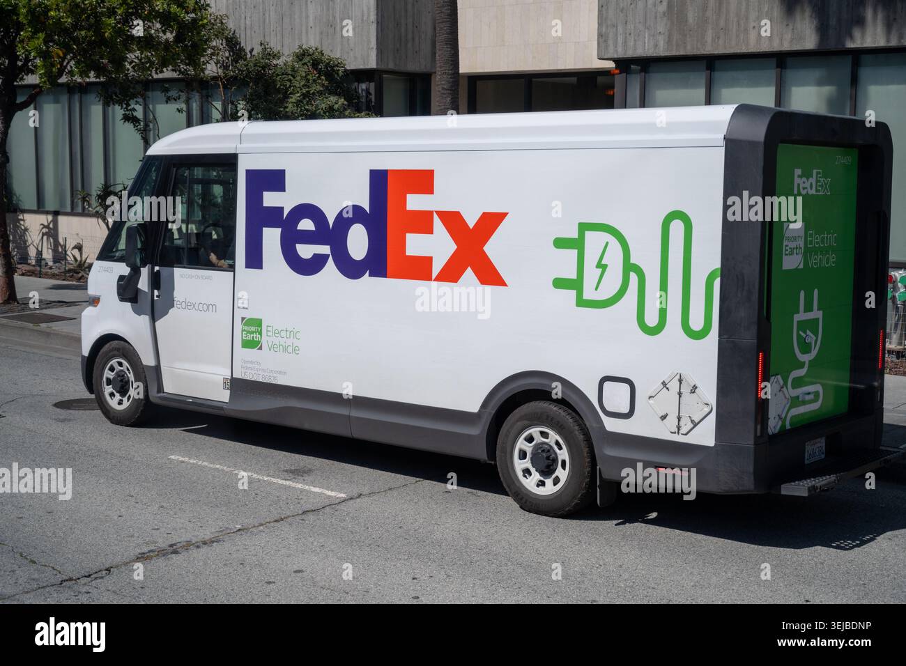 FedEx electric delivery van with sustainability branding parked on city ...