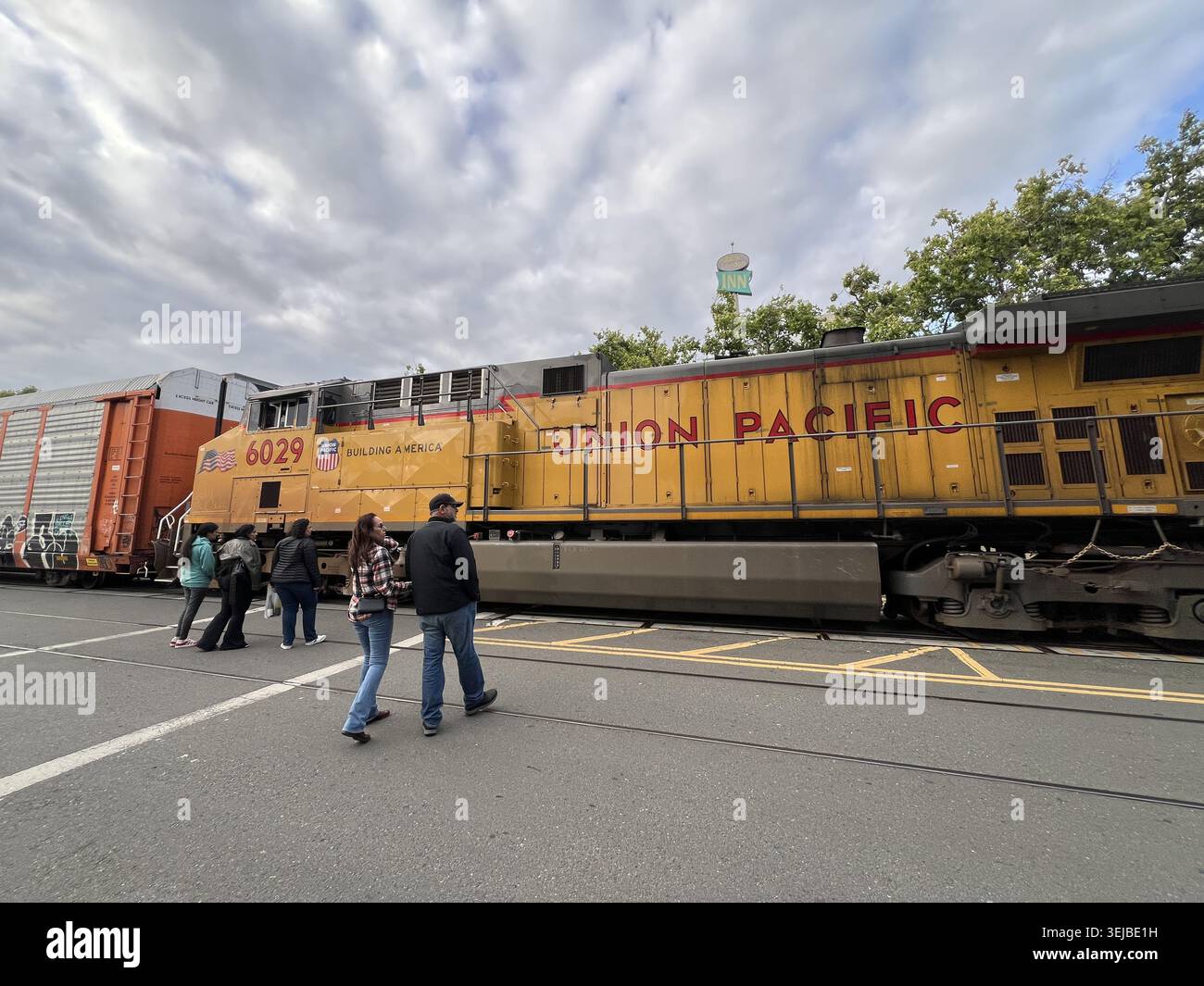 Pedestrians approach a Union Pacific freight train traveling past Jack ...