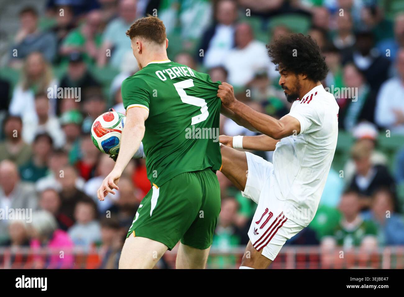 Qatar's Akram Afif, right, challenges for the ball with Ireland's Jake ...