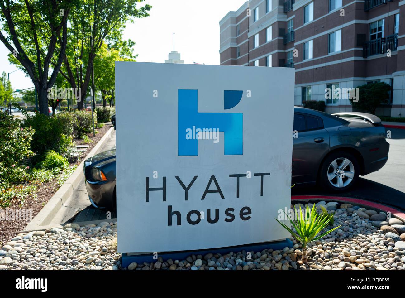 Hyatt House hotel sign with logo in landscaped parking area on a sunny ...