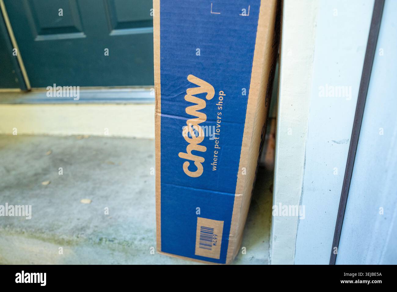 Close-up of shipping box for pet products company Chewy on the front ...