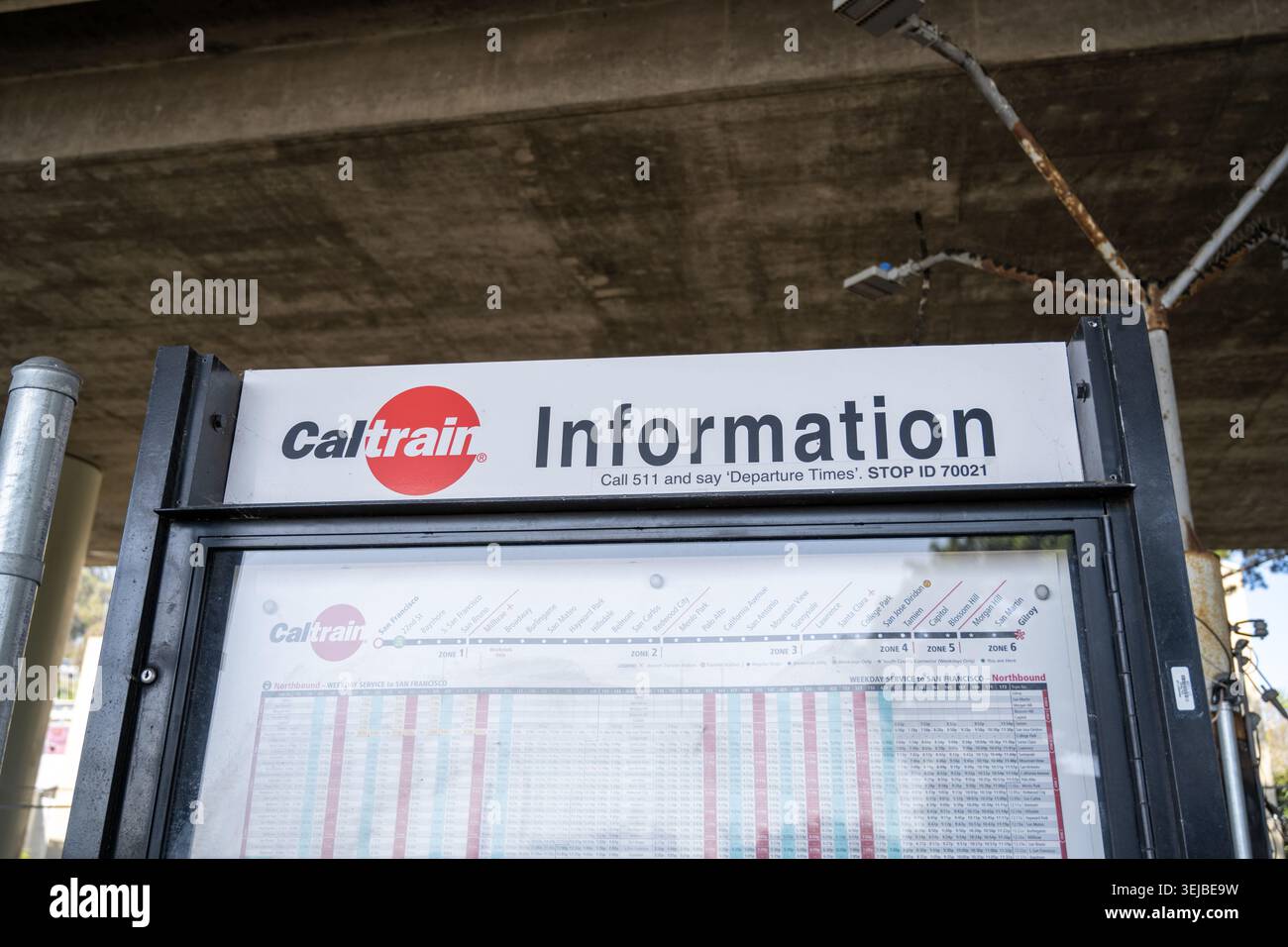Caltrain information sign and timetable display at commuter rail ...