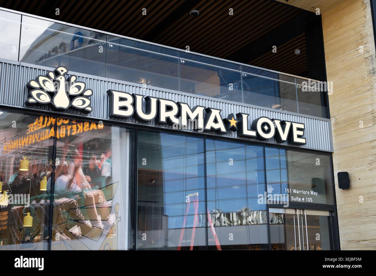 Exterior of Burma Love restaurant with illuminated sign and peacock ...