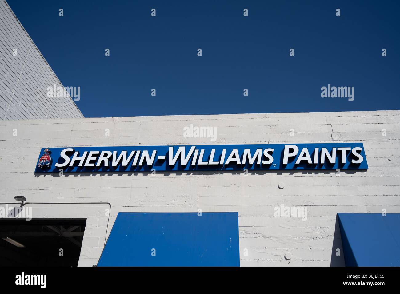 Sherwin-Williams Paints sign on exterior of white building under clear ...