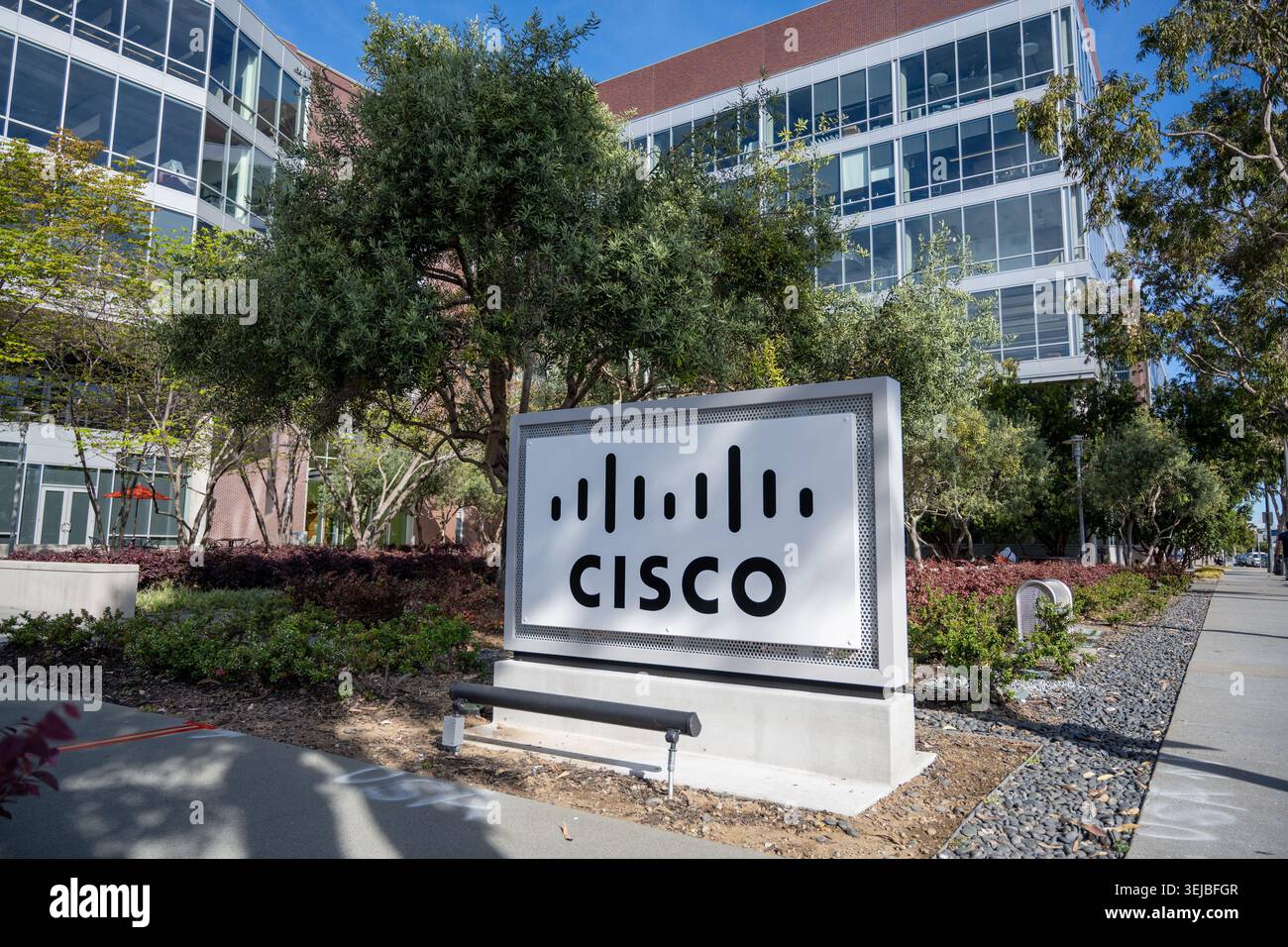 Cisco logo sign in landscaped area outside modern glass office building ...