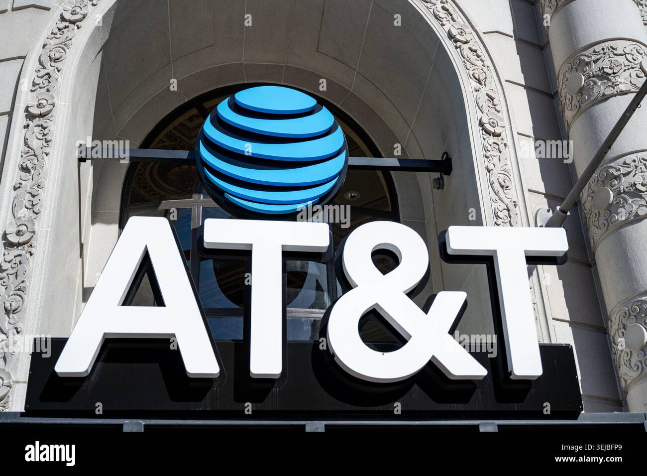 AT&T logo and signage on ornate historic building facade in sunlight ...