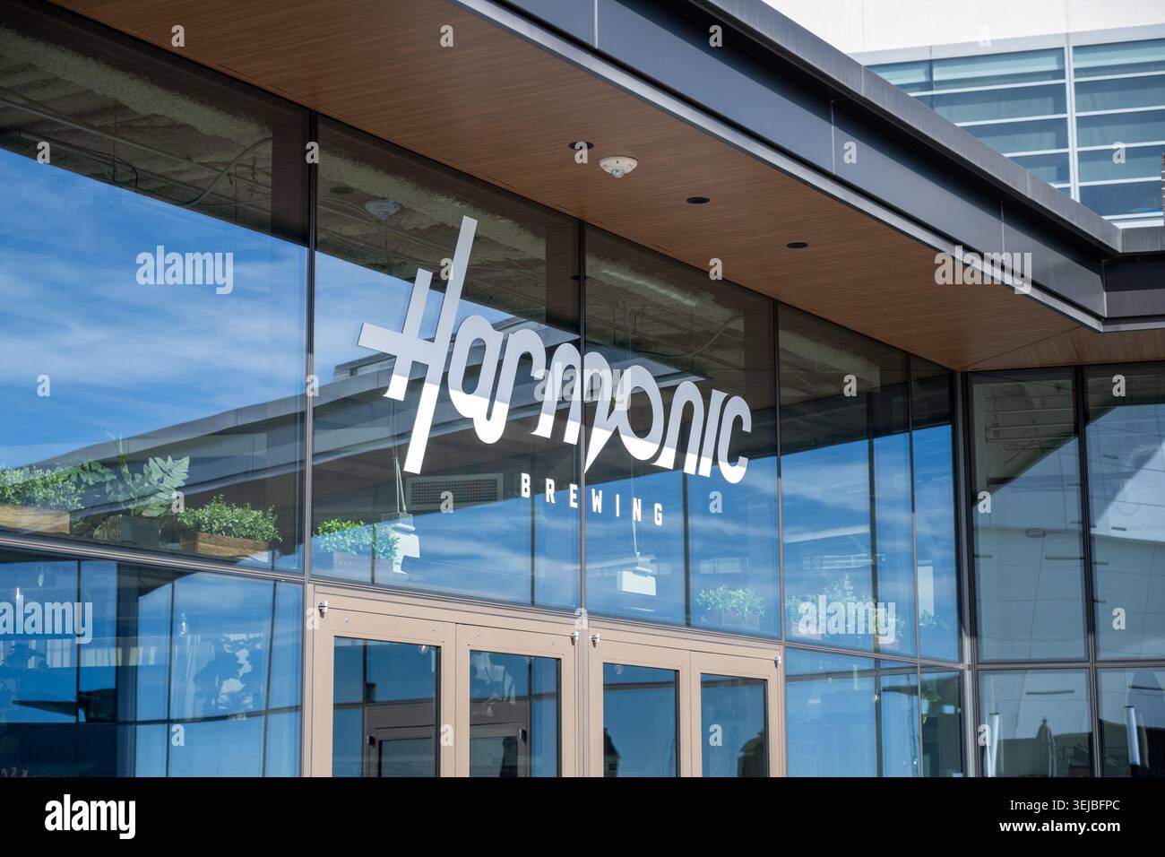Exterior of Harmonic Brewing building with large logo on glass facade ...