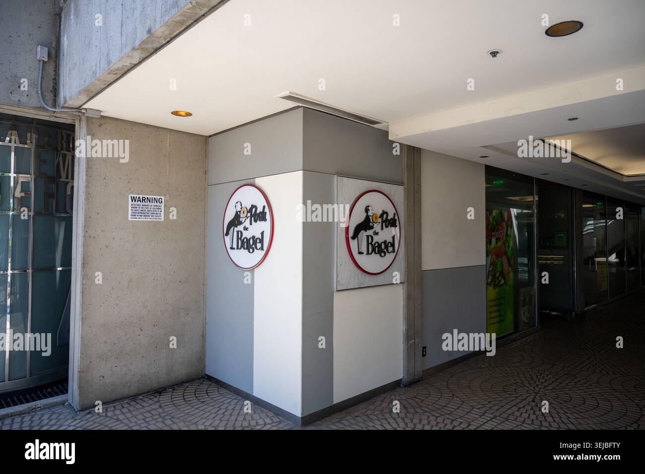 Posh Bagel signage on corner wall in covered passageway of commercial ...