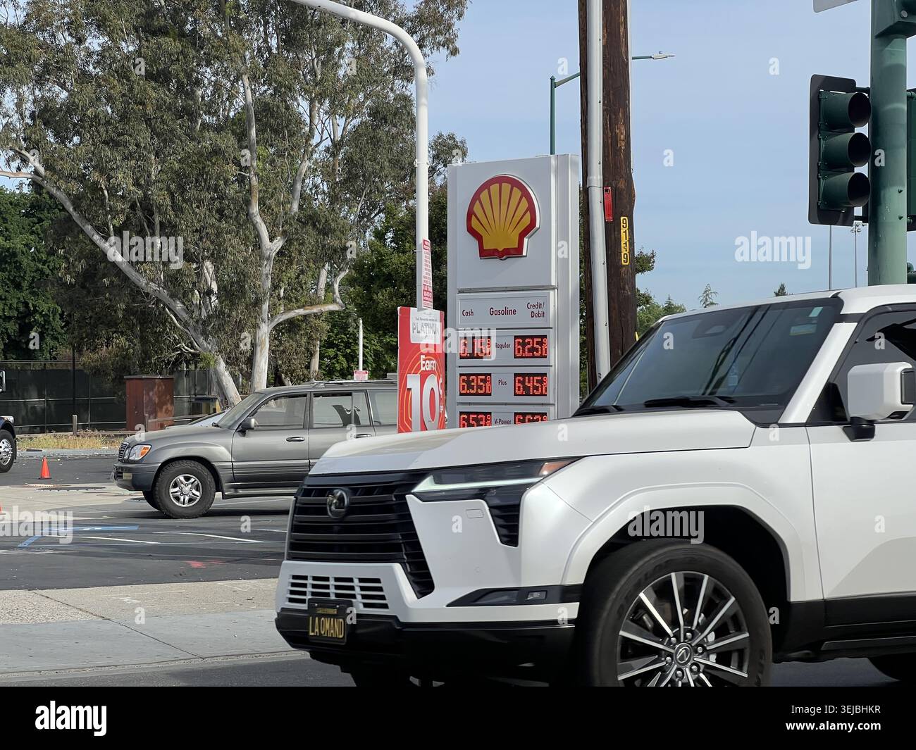 A large vehicle is seen passing by a Shell gas station with board ...