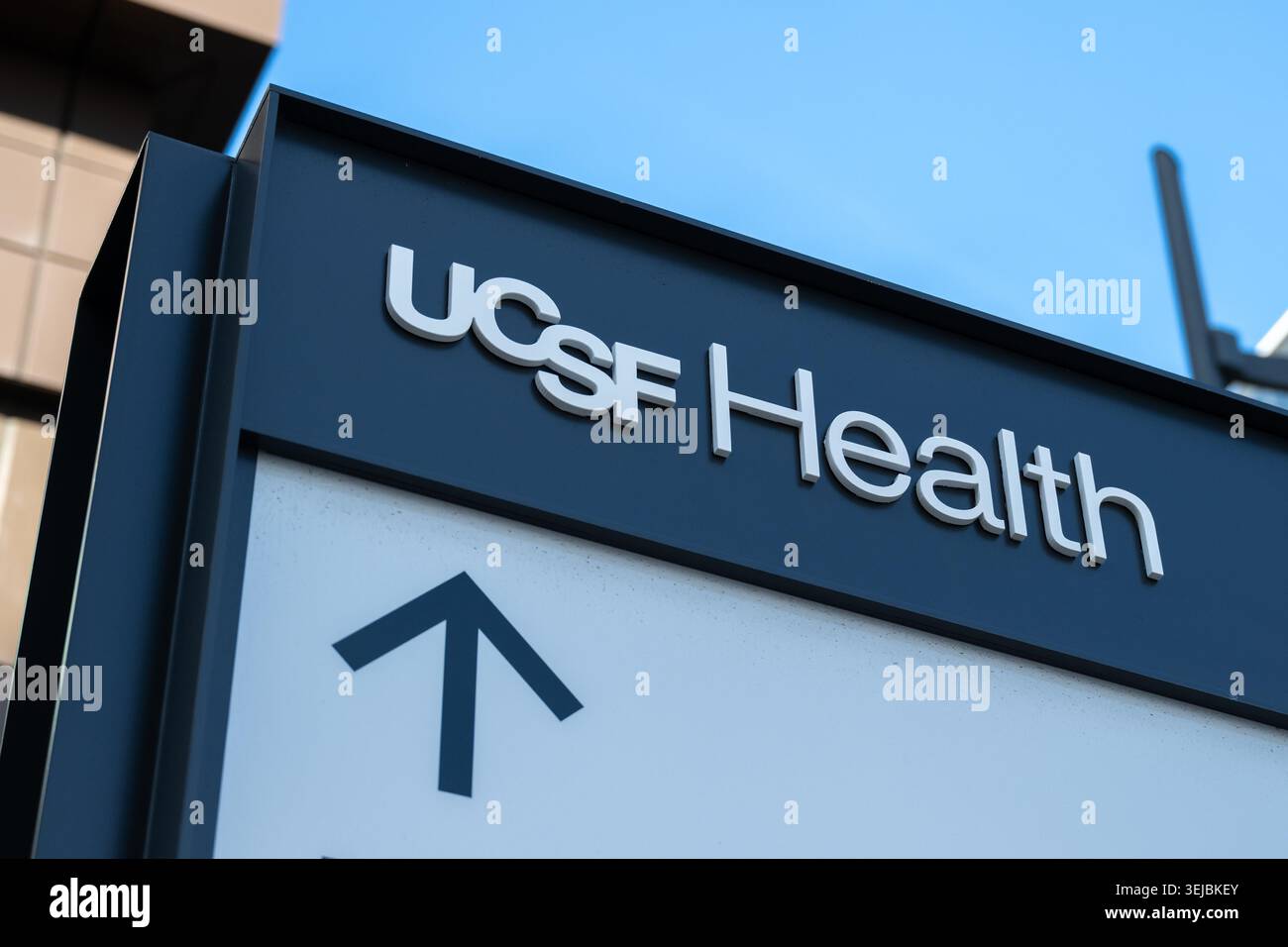 Directional sign with UCSF Health logo and arrow against blue sky, San ...