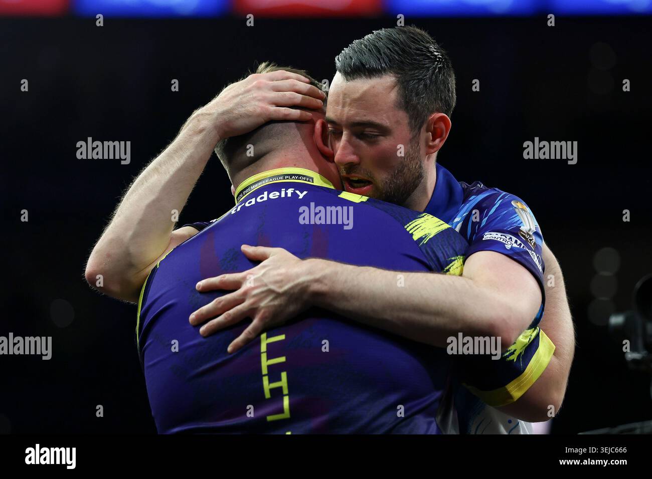 Luke Humphries embraces an emotional Luke Littler after the 2026 BetMGM ...