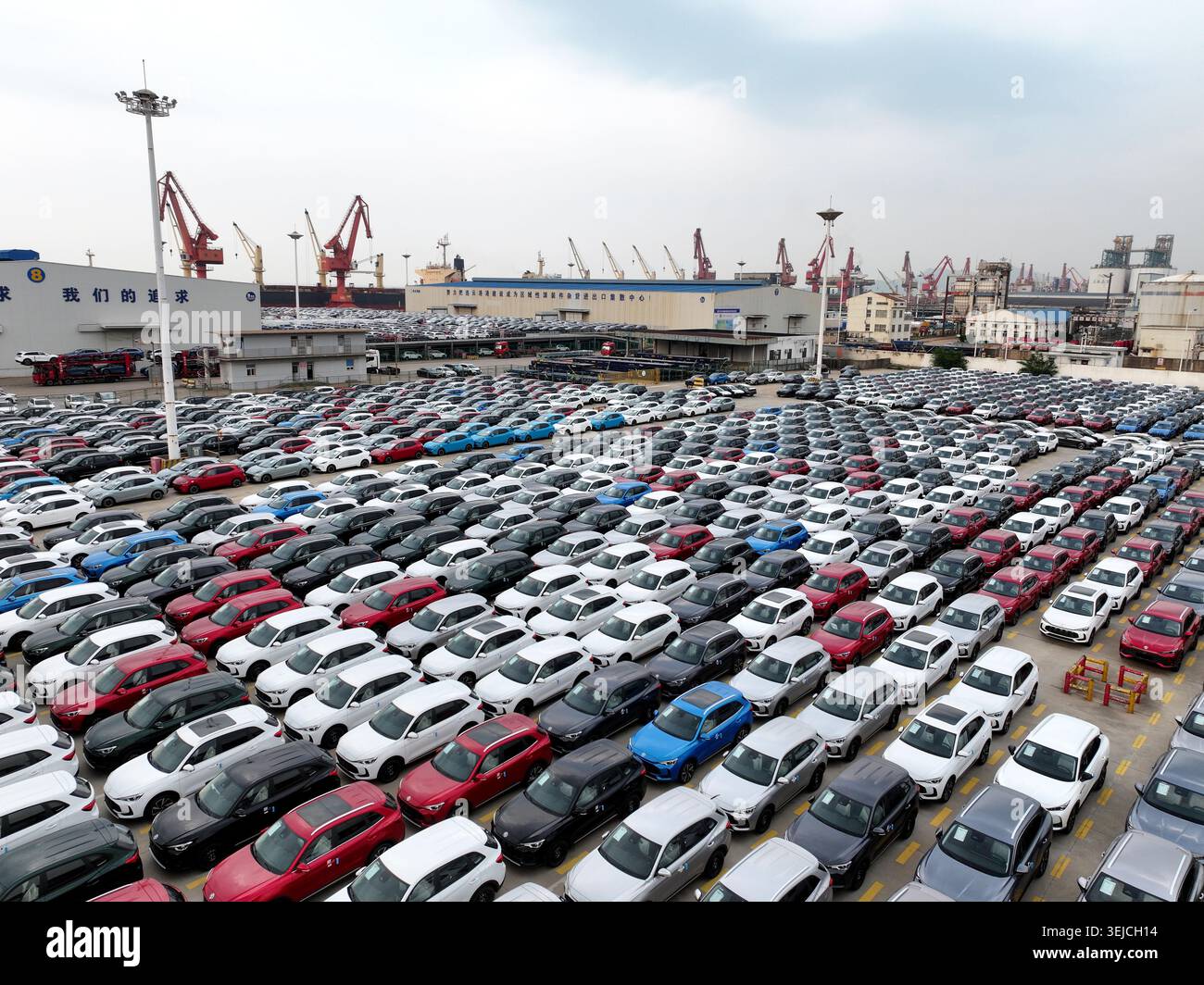Workers prepare a batch of domestically produced cars for export at the ...