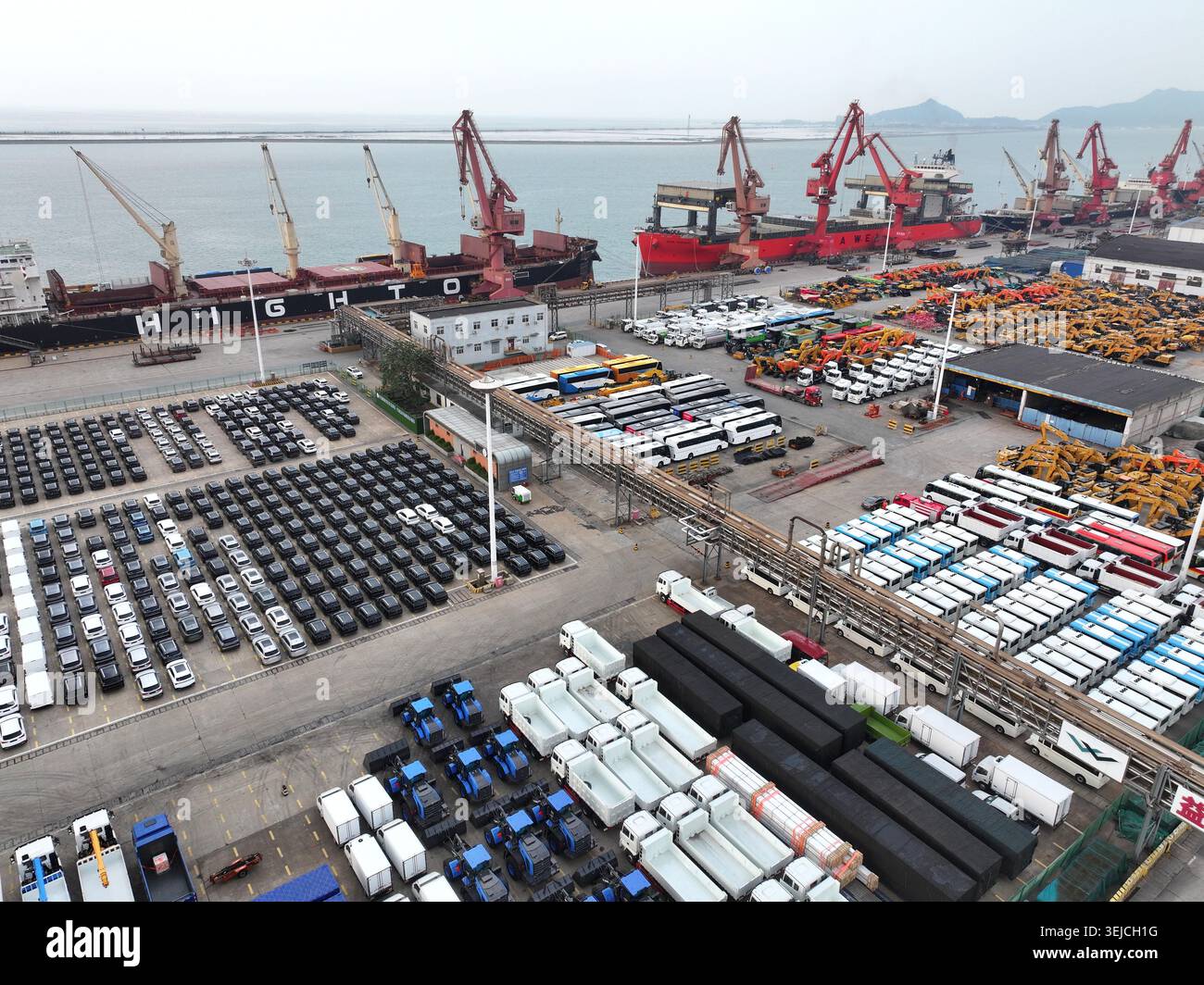 Workers prepare a batch of domestically produced cars for export at the ...