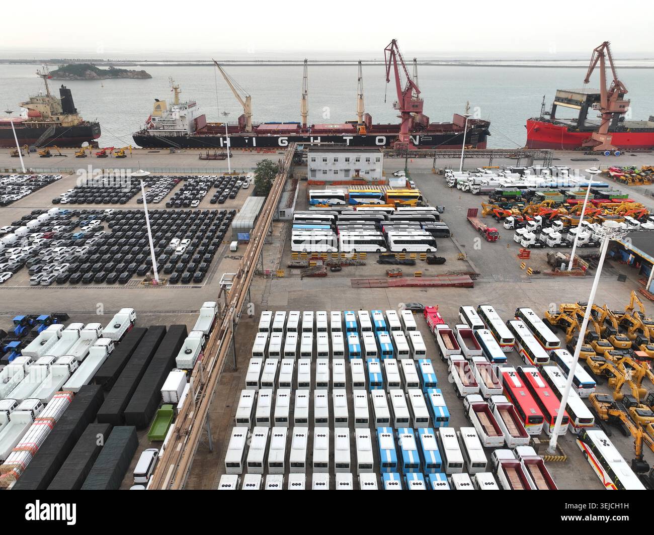 Workers prepare a batch of domestically produced cars for export at the ...