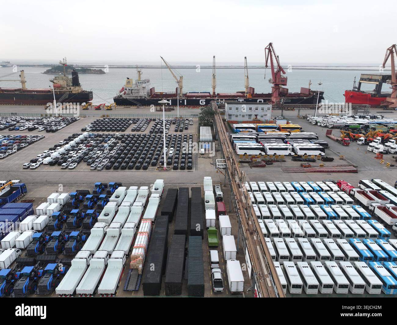 Workers prepare a batch of domestically produced cars for export at the ...