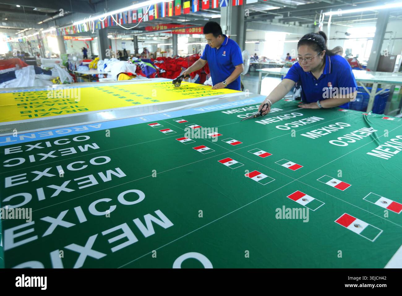 Workers produce flags at Qingdao Wonderlon Textile Technology Co., Ltd ...