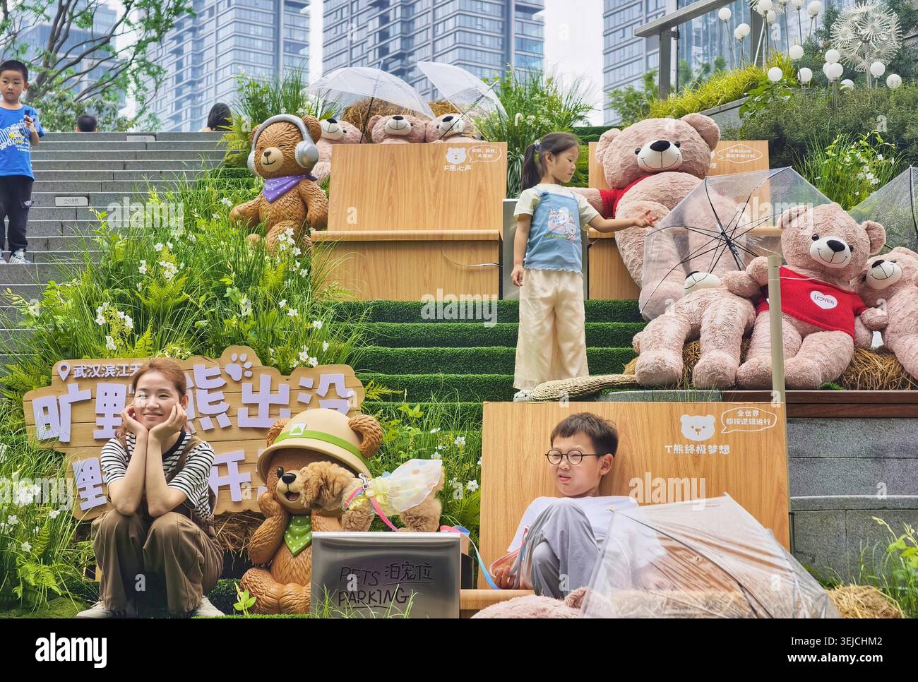 Teddy bears holding umbrellas sit on steps to welcome visitors during ...