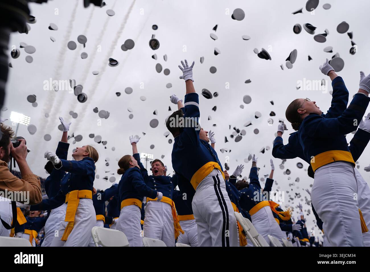 Cadets take part in the hat toss during the graduation ceremony ...