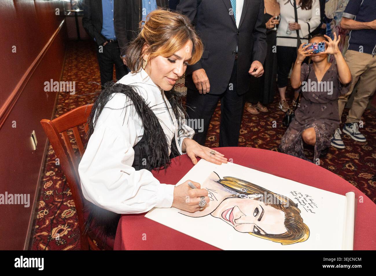 Shoshana Bean signs caricature of her as she is honored with a portrait ...