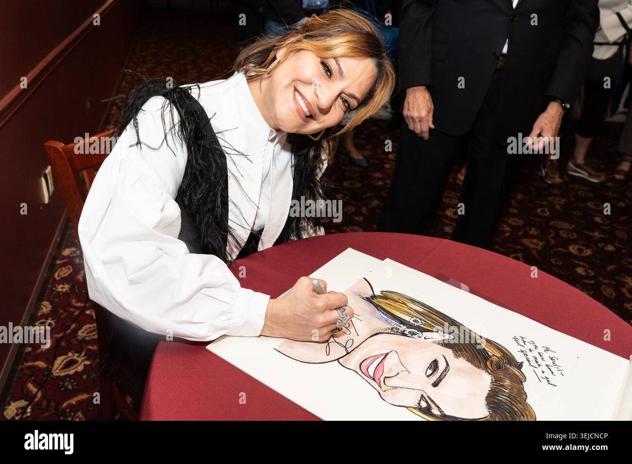 Shoshana Bean signs caricature of her as she is honored with a portrait ...