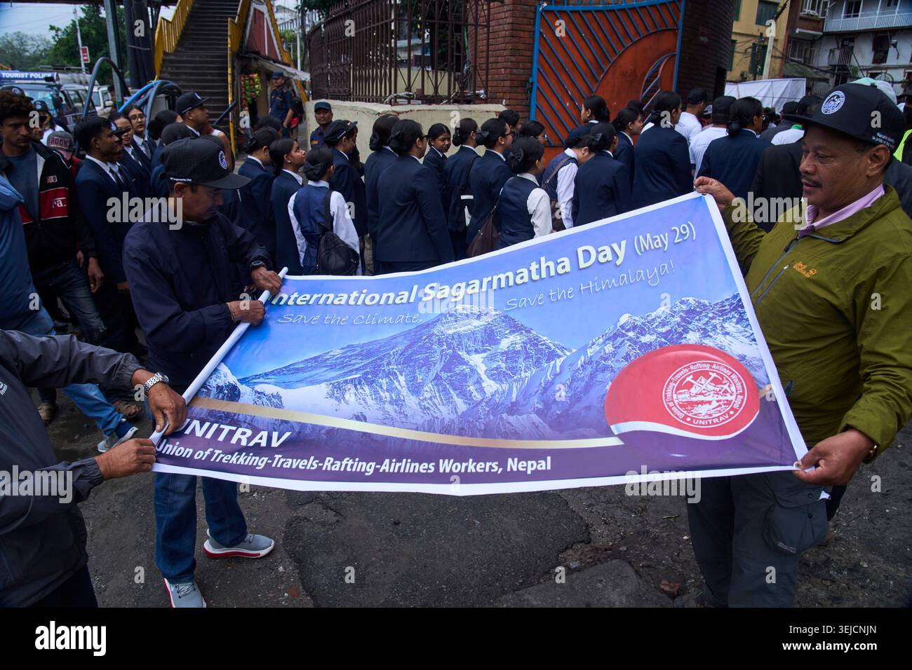 Nepalese people carry a banner with the photo of Mount Everest during a ...
