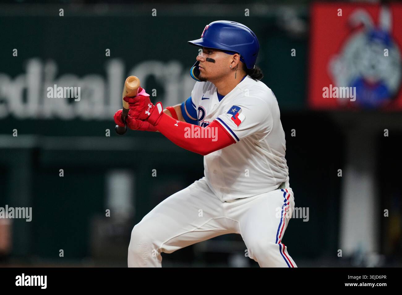 Texas Rangers' Alejandro Osuna attempts to bunt during a baseball game ...