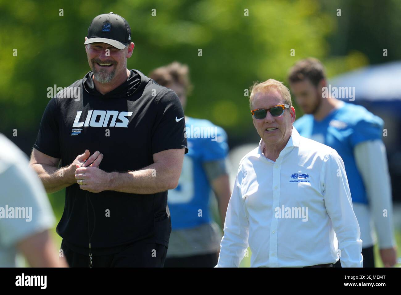 Detroit Lions head coach Dan Campbell, left, smiles with owner and vice ...