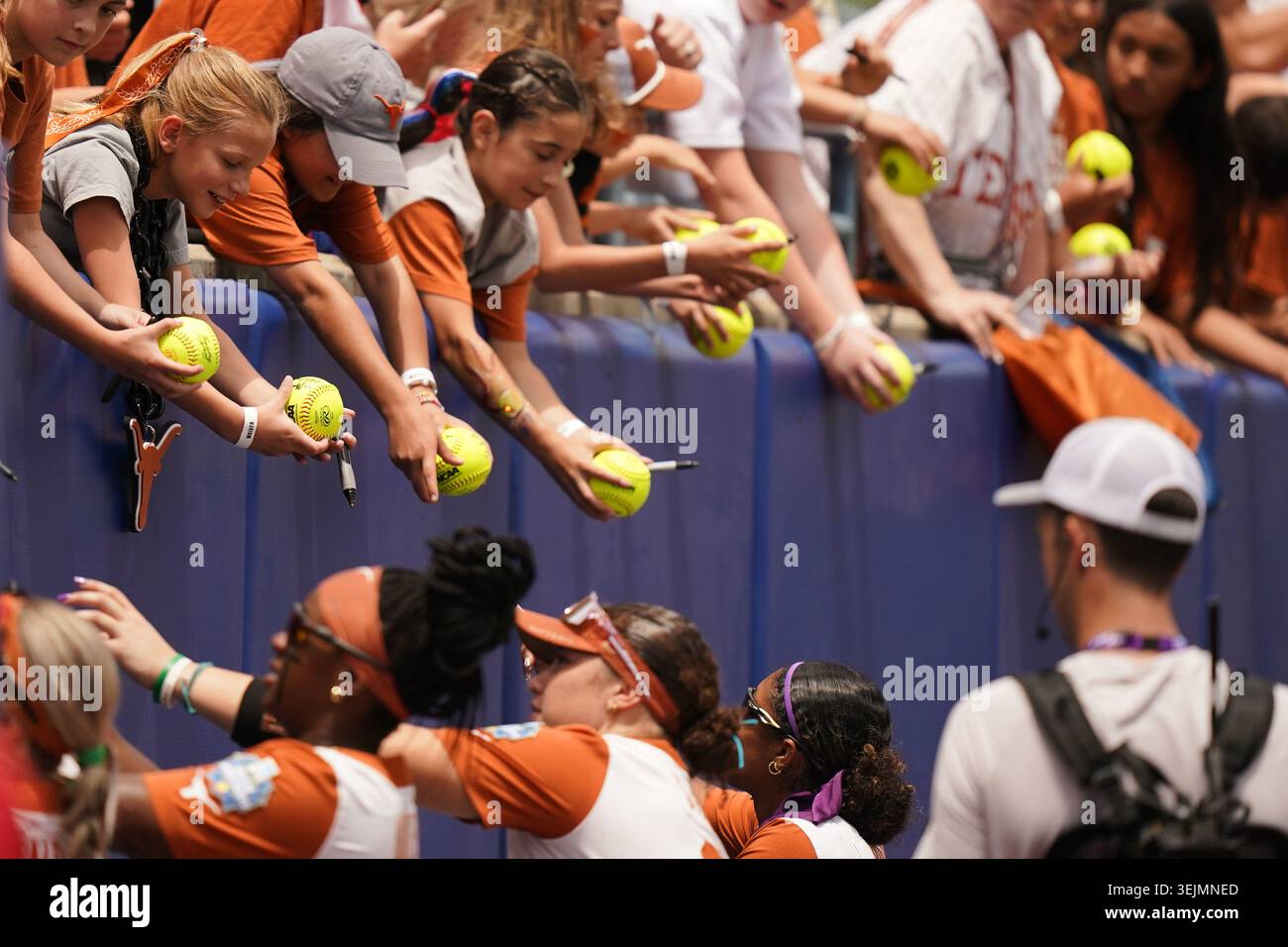 Texas players give autographs to fans before an NCAA softball Women's ...
