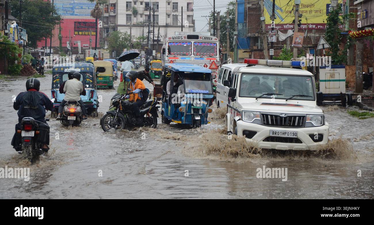 PATNA, INDIA - MAY 29: Vehicles crossing in waterlogged rain water ...