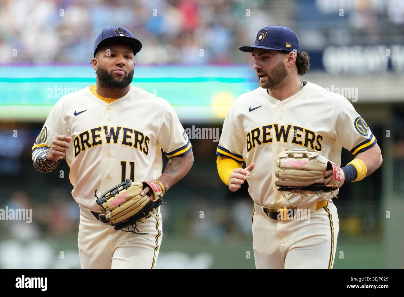 Milwaukee Brewers' Jackson Chourio talks with Garrett Mitchell during a ...