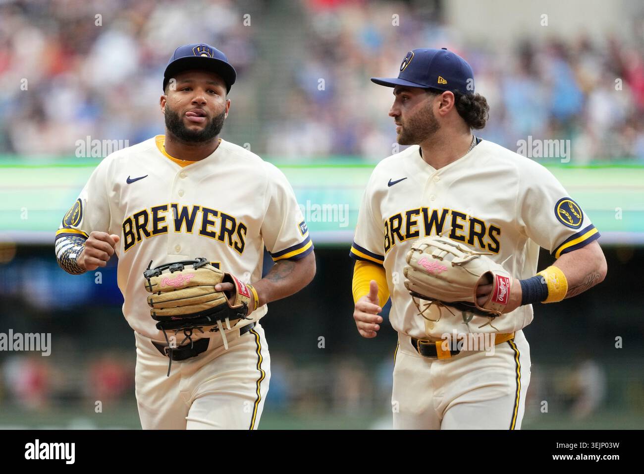 Milwaukee Brewers' Jackson Chourio talks with Garrett Mitchell during a ...