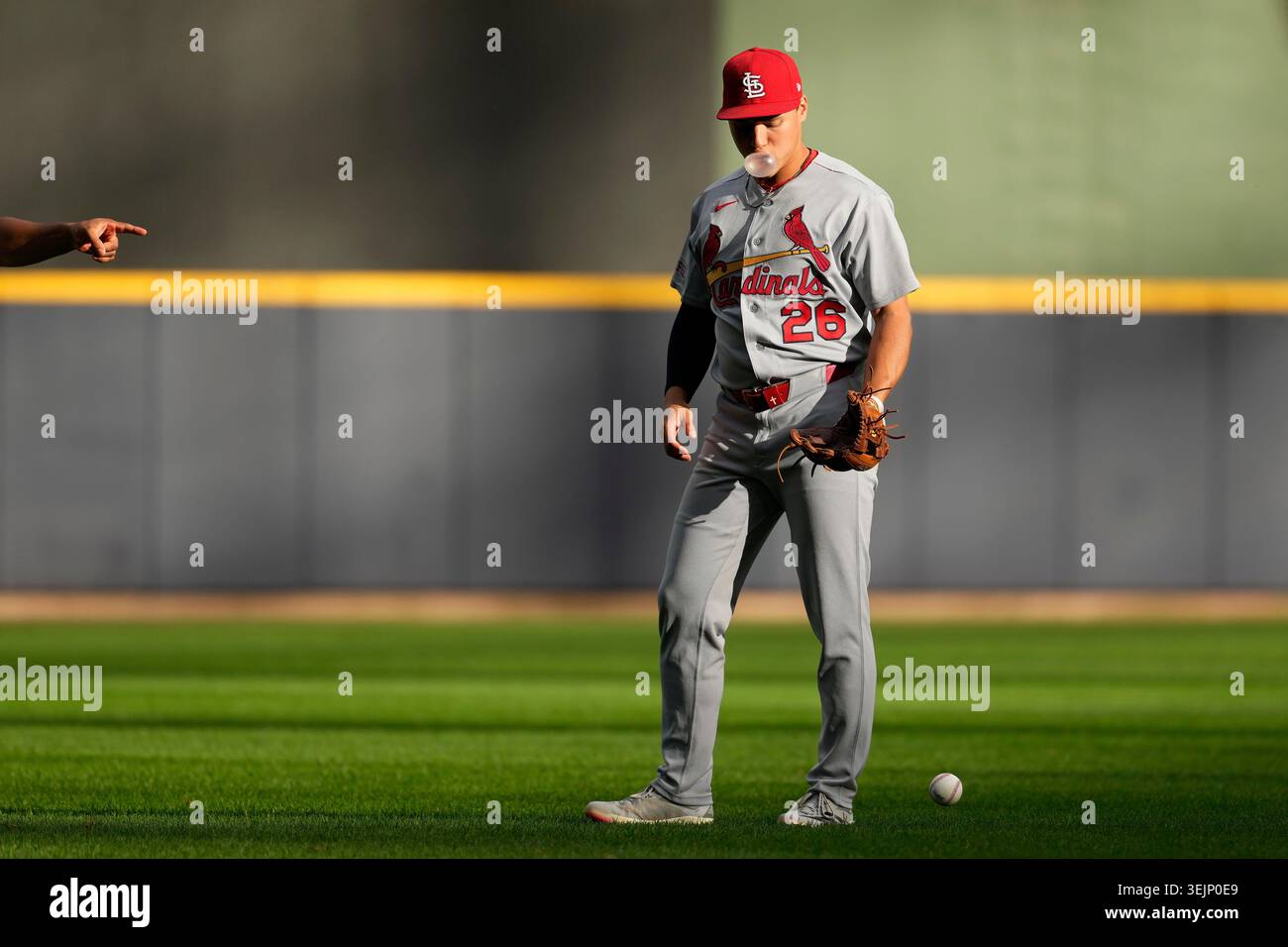 St. Louis Cardinals' JJ Wetherholt blows a bubble as he warms up before ...