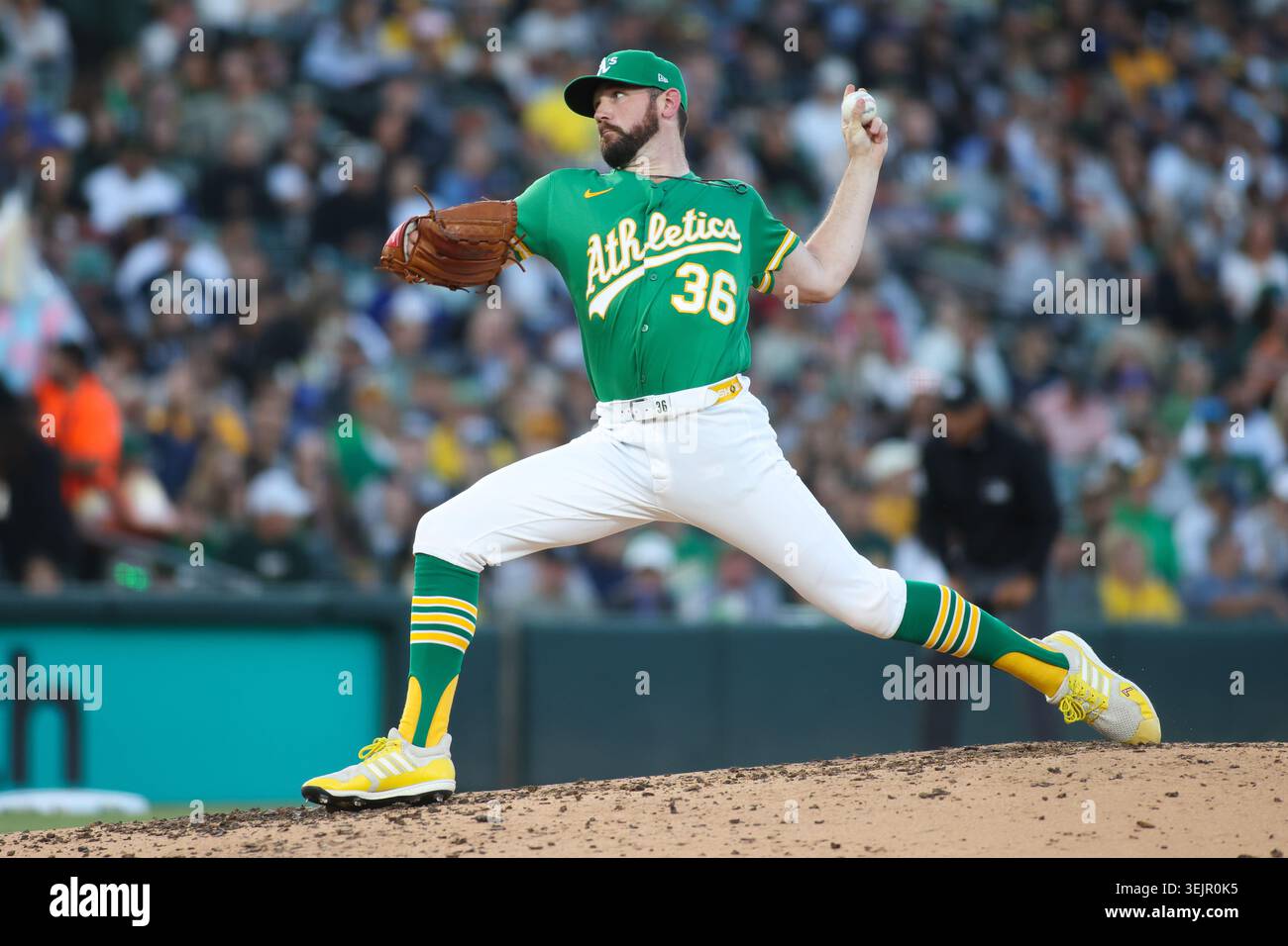 Athletics pitcher Hogan Harris throws to a New York Yankees batter ...