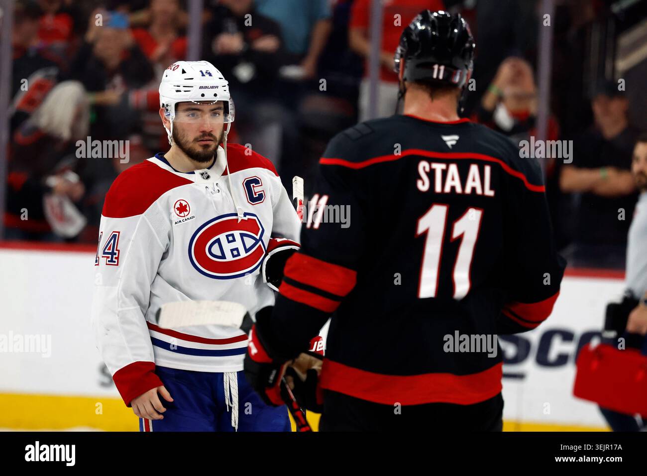 Montreal Canadiens' Nick Suzuki (14) congratulates Carolina Hurricanes ...