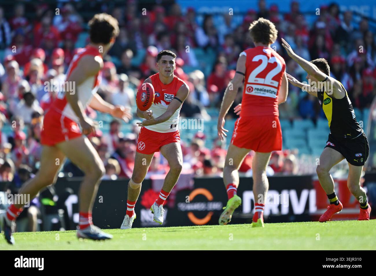 Justin McInerney of the Swans handballs during the AFL Round 12 match ...