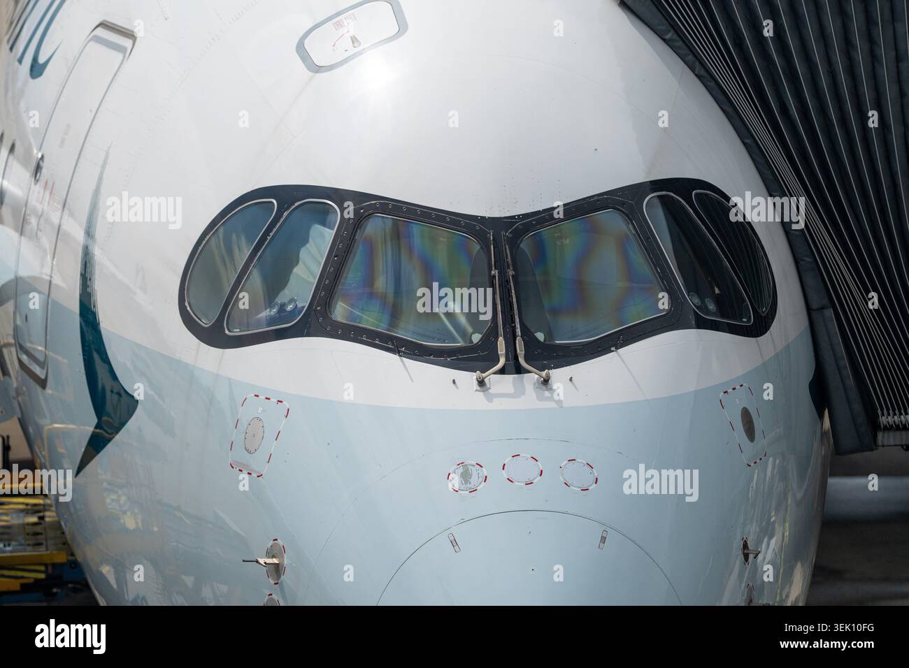 A Cathay Pacific plane parked at a gate at Hong Kong International ...
