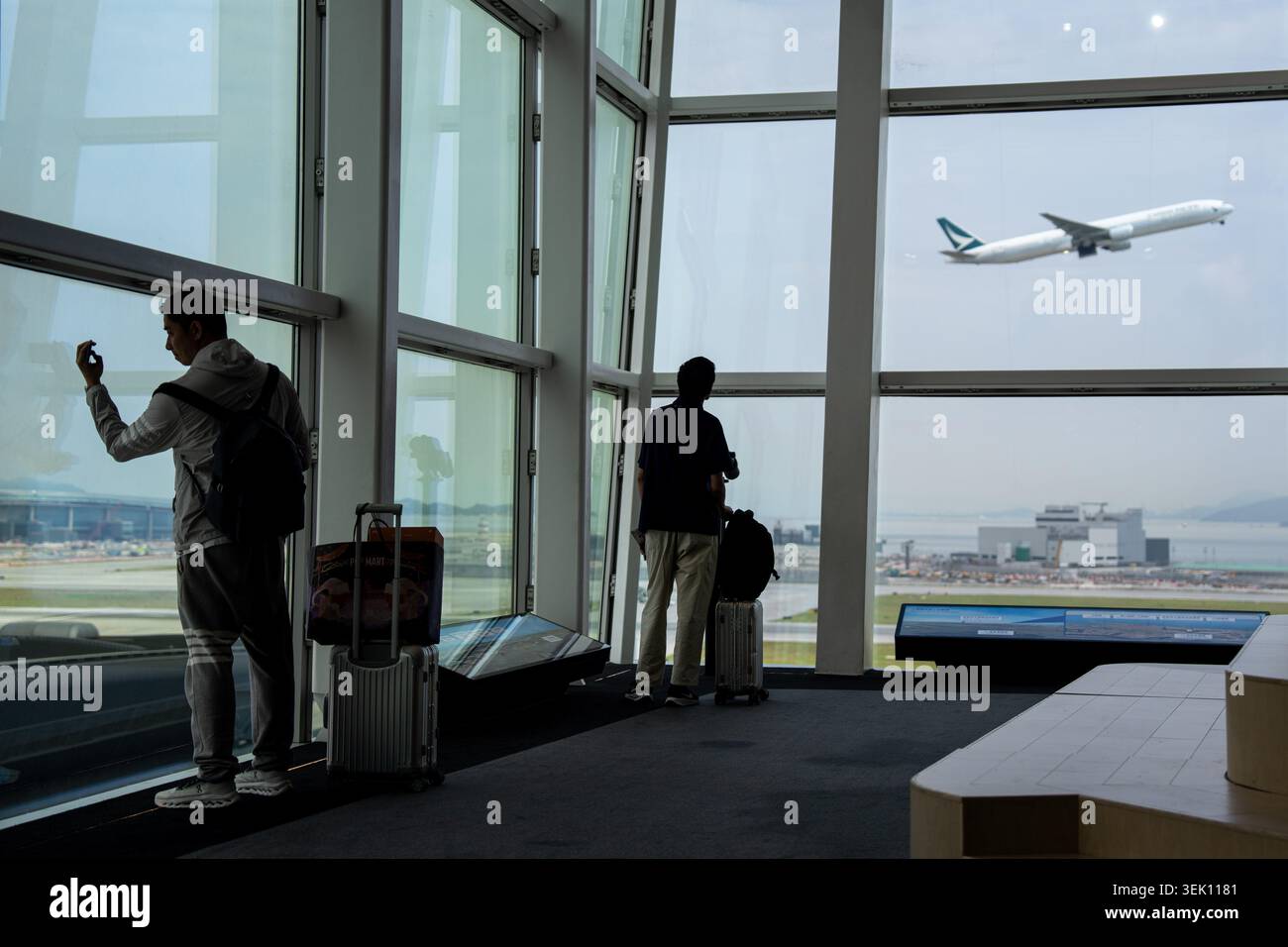 People looking at planes taking off from Hong Kong International ...