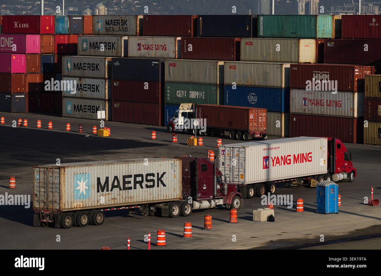 Trucks carrying cargo containers arrive at the Port of Vancouver ...